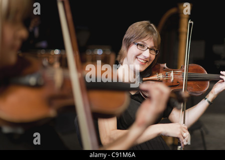 Violin players in orchestra Stock Photo - Alamy