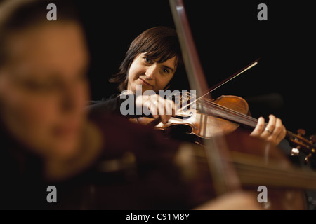Violin players in orchestra Stock Photo - Alamy