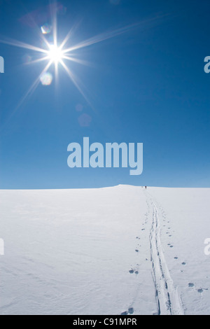 Two backcountry skiers skin in the Beehive Basin near Big Sky, Montana ...