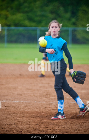 A female baseball player pitching a ball Stock Photo - Alamy