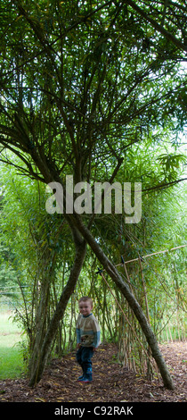 Toddler in willow maze Stock Photo - Alamy