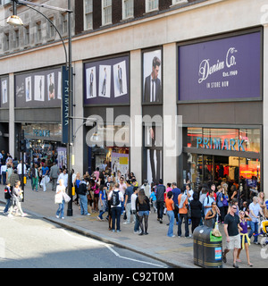 Busy pavement with shoppers outside Primark fast fashion clothing ...
