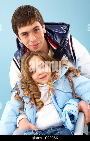 Lovely child girl, wearing blue summer dress and pink bolero, stacking ...