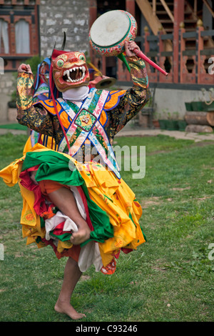 A masked dancer with a lag nga performs Drametse Nga Cham at the ...