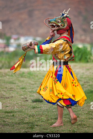 A masked dancer with a lag nga performs Drametse Nga Cham at the ...
