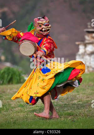 A masked dancer with a lag nga performs Drametse Nga Cham at the ...