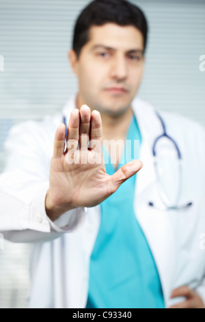 young doctor warning finger up isolated on white Stock Photo - Alamy