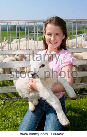 Portrait of girl (6-7) holding lamb Stock Photo: 85778075 - Alamy