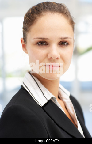Portrait of young successful businesswoman at office. She sits at the ...