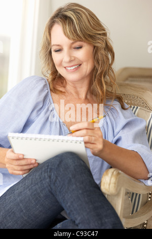 Middle age artist woman at art studio covering one eye with hand ...