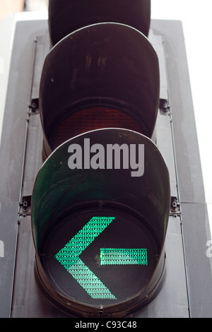 Traffic light with green arrow left and right turn signal against blue ...