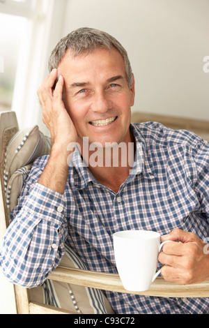Middle age handsome man drinking a take away cup of coffee outdoors at ...
