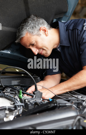 Man working inside the engine compartment of a van outdoors Stock Photo ...
