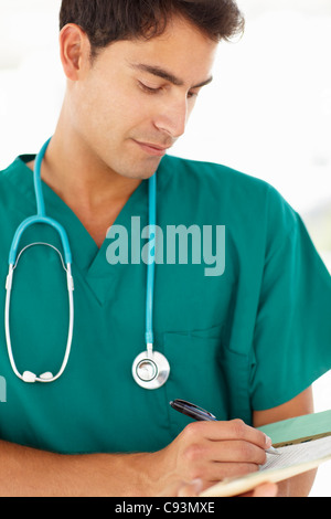 Male student doctor with stethoscope writing on white background Stock ...