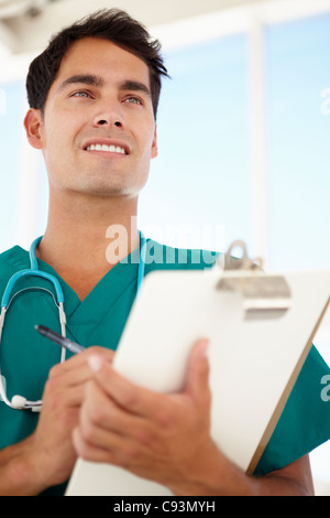 Male student doctor with stethoscope writing on white background Stock ...
