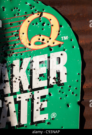An antique metal sign riddled with rust and bullet holes Stock Photo ...