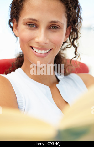 A young woman reading a book at home Stock Photo - Alamy