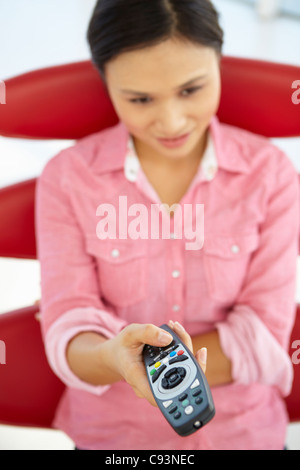 Young woman with remote control Stock Photo - Alamy