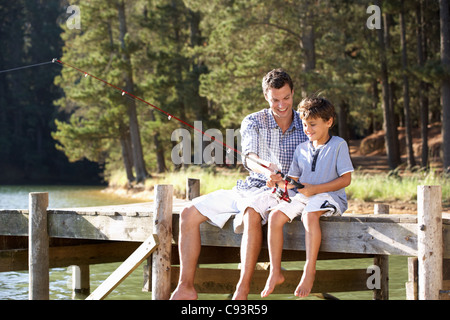 Adult son showing to his old father a family photo Stock Photo - Alamy
