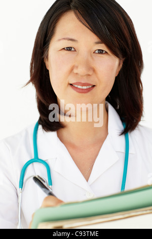 Asian female doctor medical professional holding blood pressure monitor ...