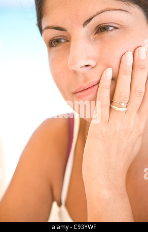 A woman is resting her chin in her right hand with bashful smile Stock ...