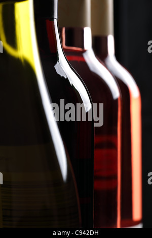Bottles glass with white wine in row on table standing in metal rack ...