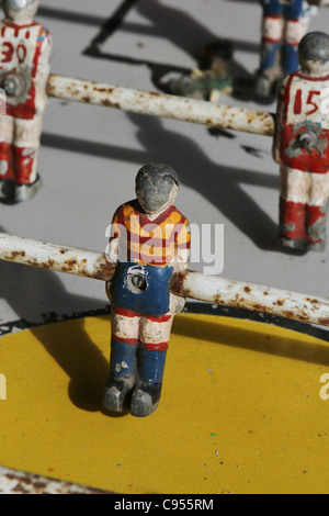 Close up of players on foosball game table for fun activity in office ...