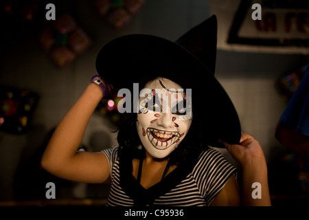 Portrait of a girl with a painted mask of a dead person on her face ...