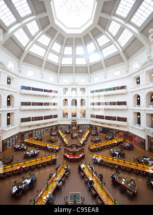 Australia Melbourne: State Library of Victoria. Visitor studying at ...