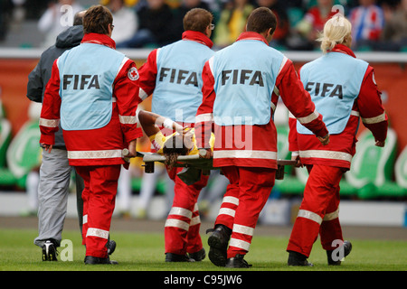 Paramedics carrying an injured football player on a stretcher Stock ...