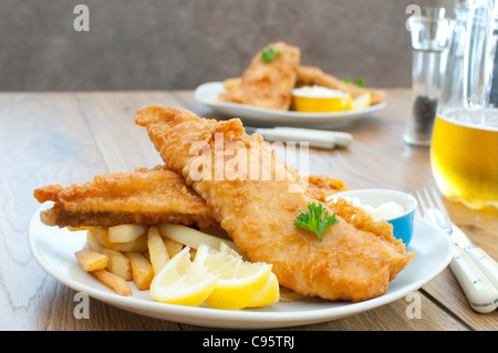 Fried battered haddock fish fillets and chips meal with mushy peas ...