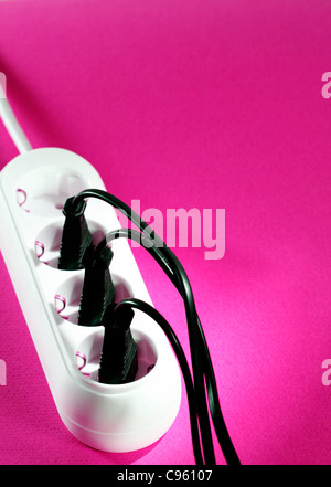 Closeup picture of a pink outlet isolated on black. Electric Power Line ...