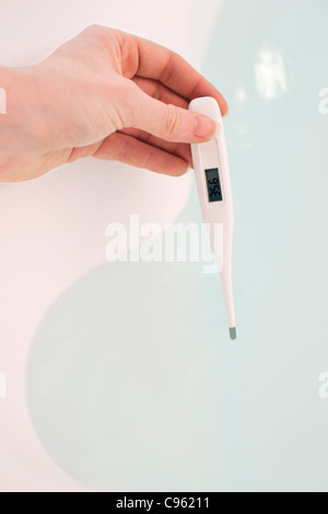 Thermometer measures the temperature of the water Stock Photo - Alamy