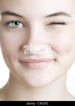 A woman winks at the camera Stock Photo - Alamy
