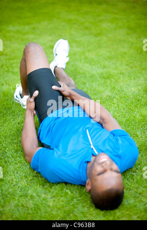 Man with cramp in thigh Stock Photo - Alamy