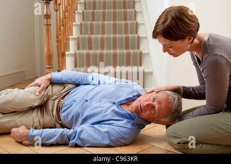 Recovery position. Man being placed in the recovery position Stock ...