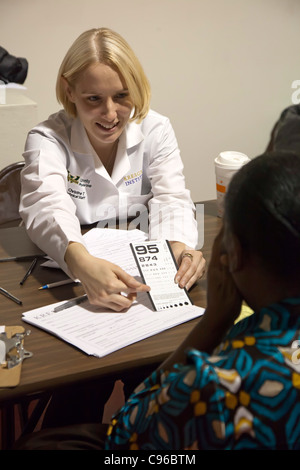 A woman has a free eye test at a screening camp in a village in ...