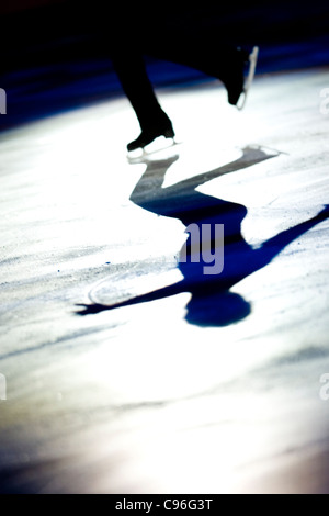 Shadow of female figure skater in action Stock Photo - Alamy