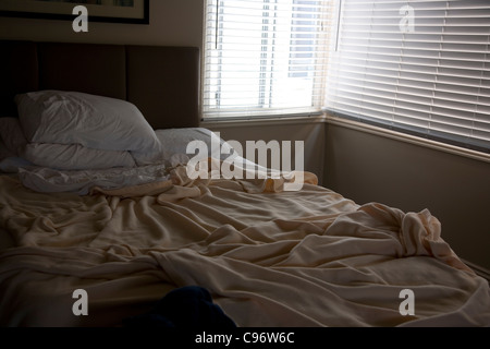 AN UNMADE BED IN A HOTEL ROOM Stock Photo: 3378302 - Alamy