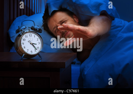 clock on blue background. early morning concept image Stock Photo - Alamy