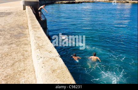 Teen boys swimming along the "Malecon" in Havana, Cuba Stock Photo - Alamy