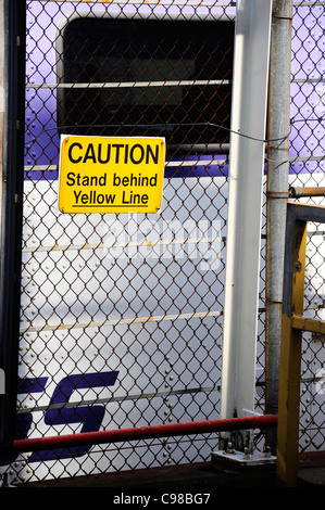 Stand behind the yellow line caution at a train platform in Kuala ...