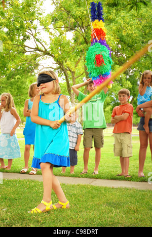 Children Hitting Pinata At Birthday Party Stock Photo - Alamy