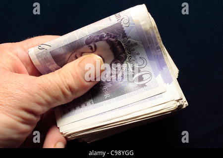 Wad of twenty pound notes cash in hands Stock Photo - Alamy
