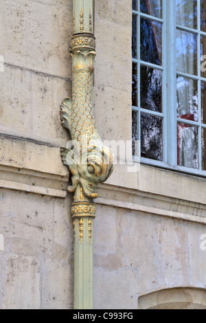Elegant gilded dolphin downspout of the Hotel De Lausun. The building ...