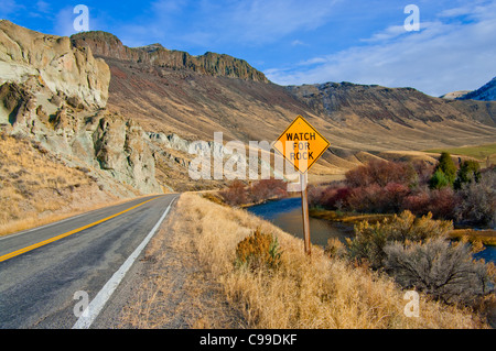 Watch For Falling Rock caution road sign Stock Photo - Alamy