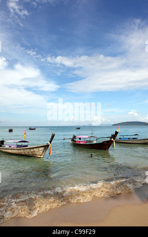 Long-tail wooden boats anchored on white beach in tropical sea at lipe ...