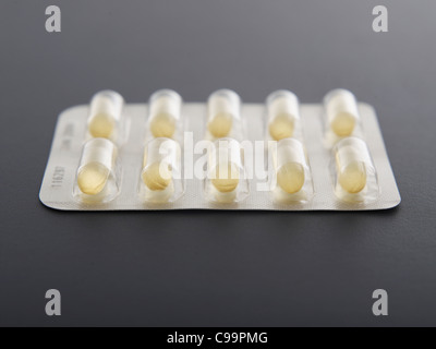pills in blister pack on vintage wooden board with organized copyspace ...