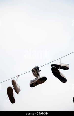 Shoes on a telephone line Stock Photo - Alamy