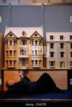 A miniatura enthusiast working on his Pennsylvanian style villa dolls ...